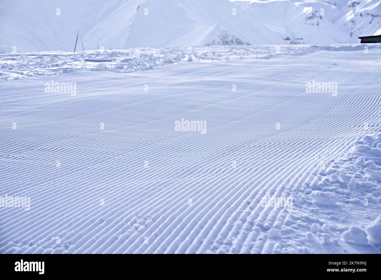 Snow lines after snowtrack at ski resort. Fresh ready ski slope looks ...