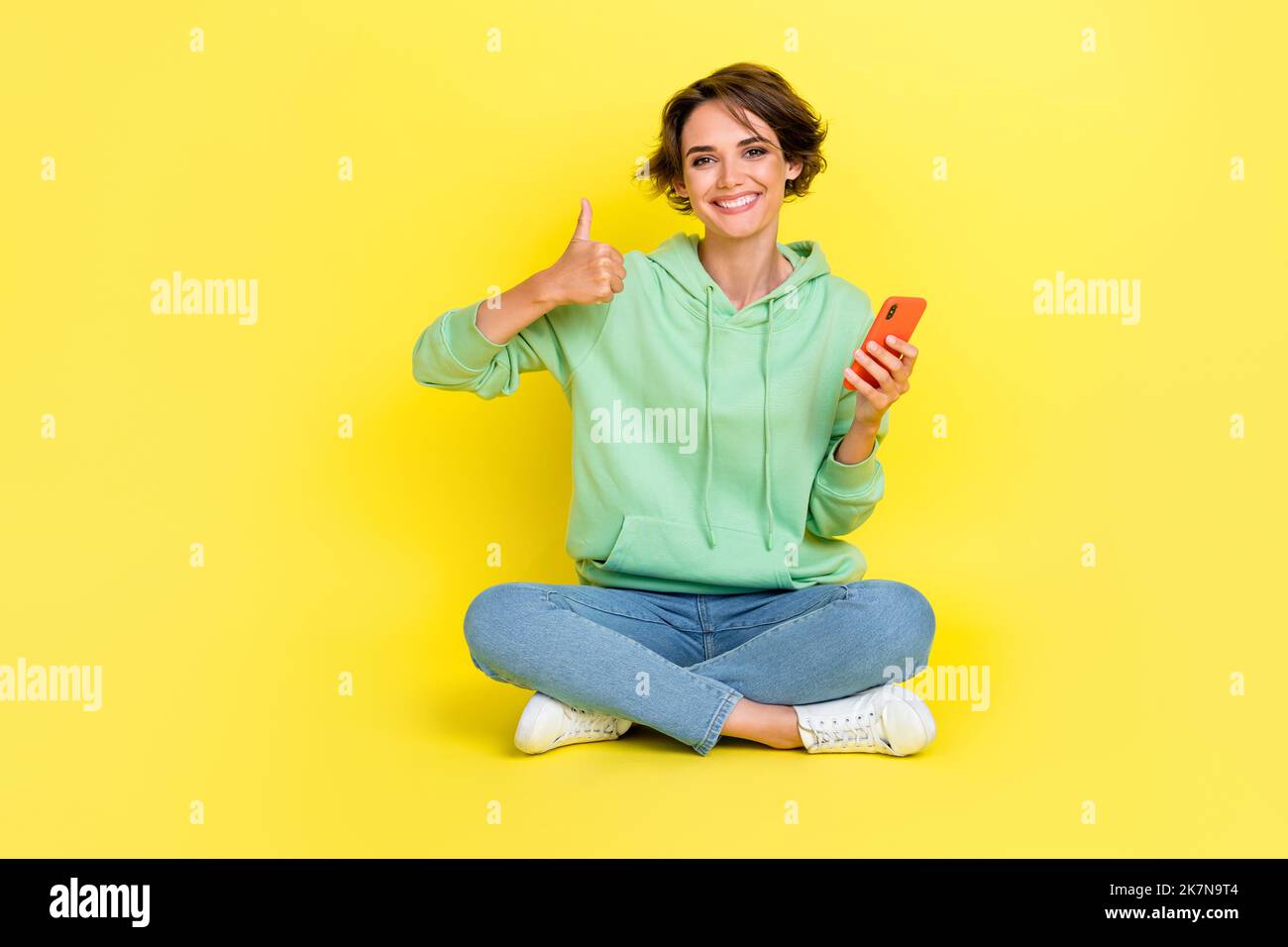 Full length photo of confident cute lady wear green hoodie thumb up ...