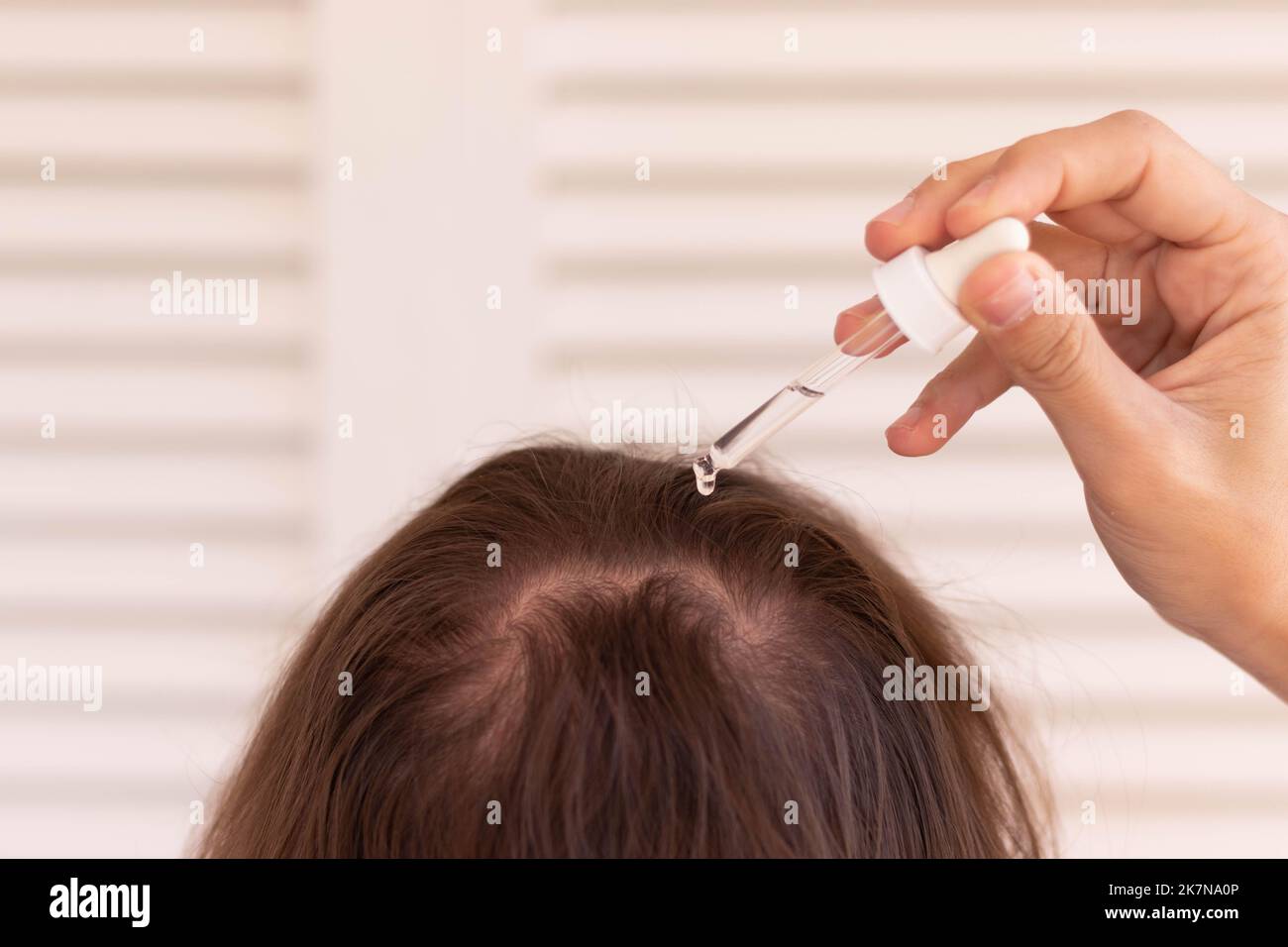 Close up view of unrecognizable young man with long hair putting hair ...