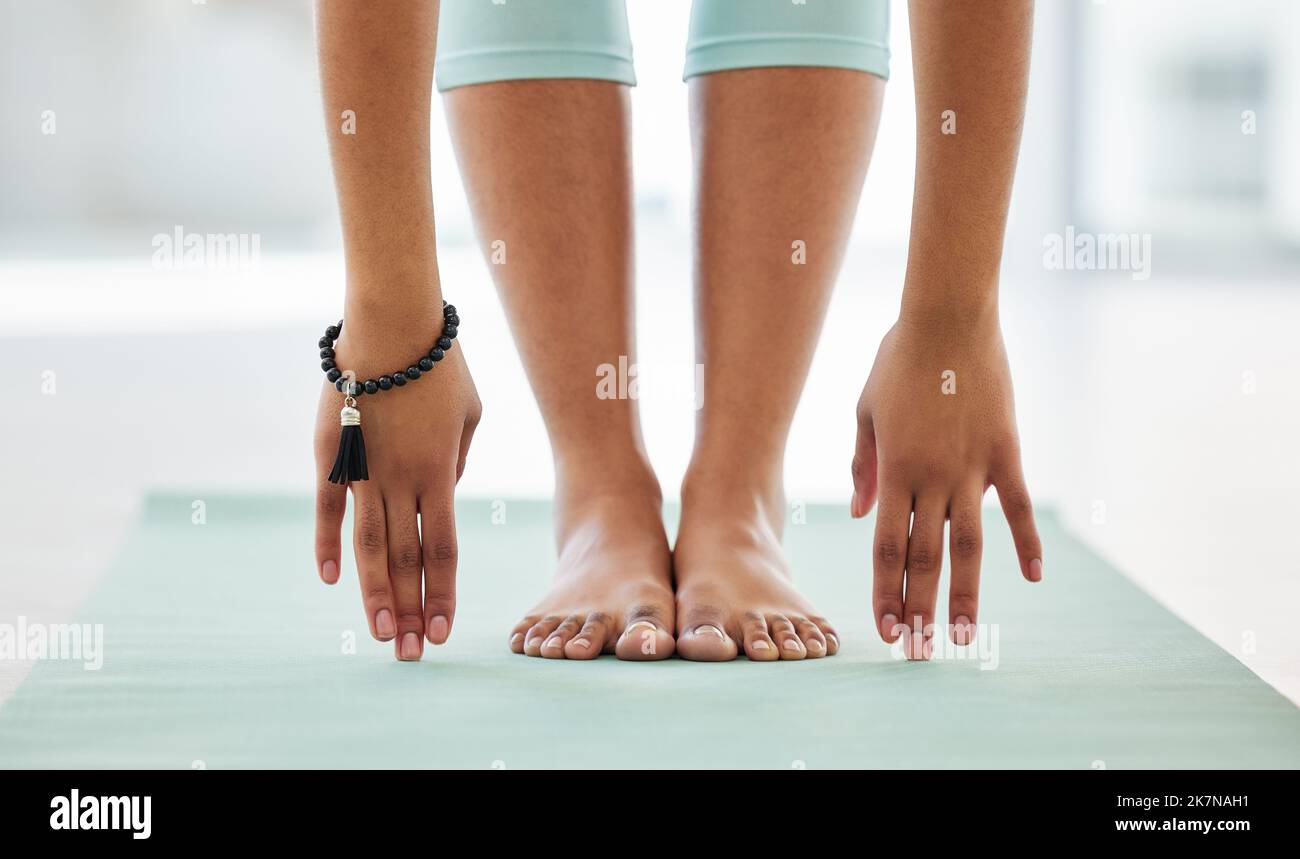 Stretching my calves. an unrecognisable woman practising yoga alone and ...