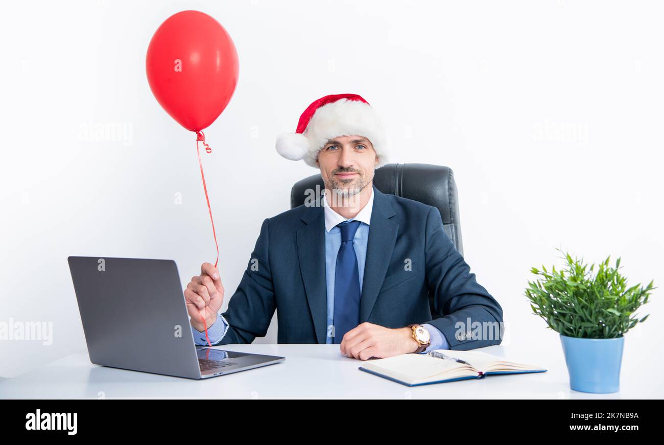 mature man wear red santa claus hat in business office hold balloon ...