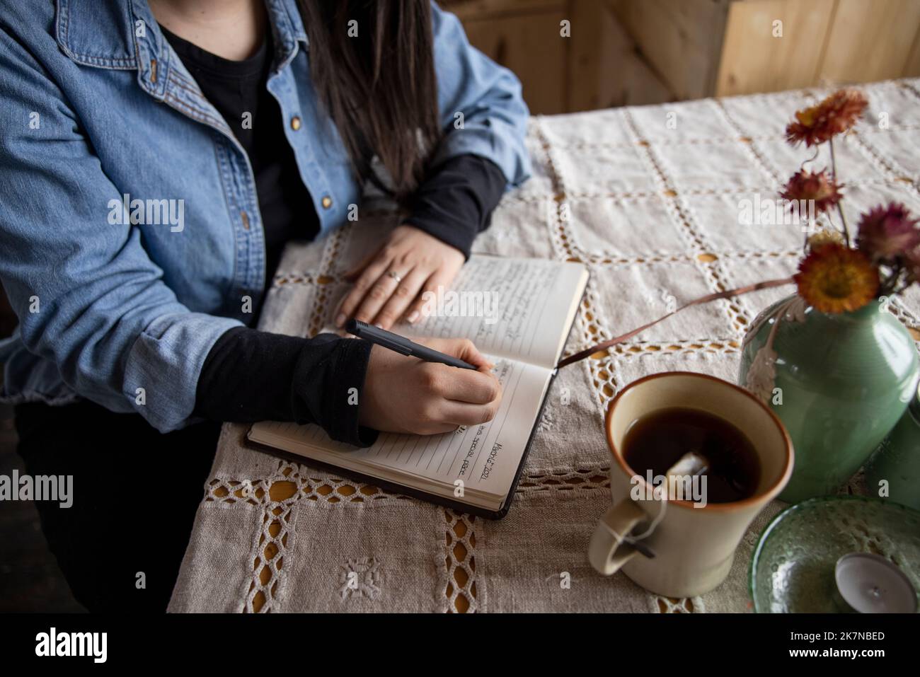 Adult writing journal kitchen table hi-res stock photography and images ...