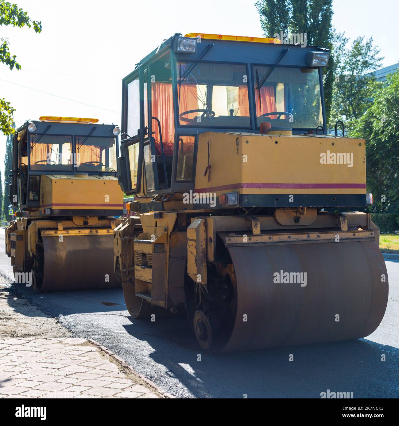 Old dirty asphalt paving machine stands idle Stock Photo - Alamy