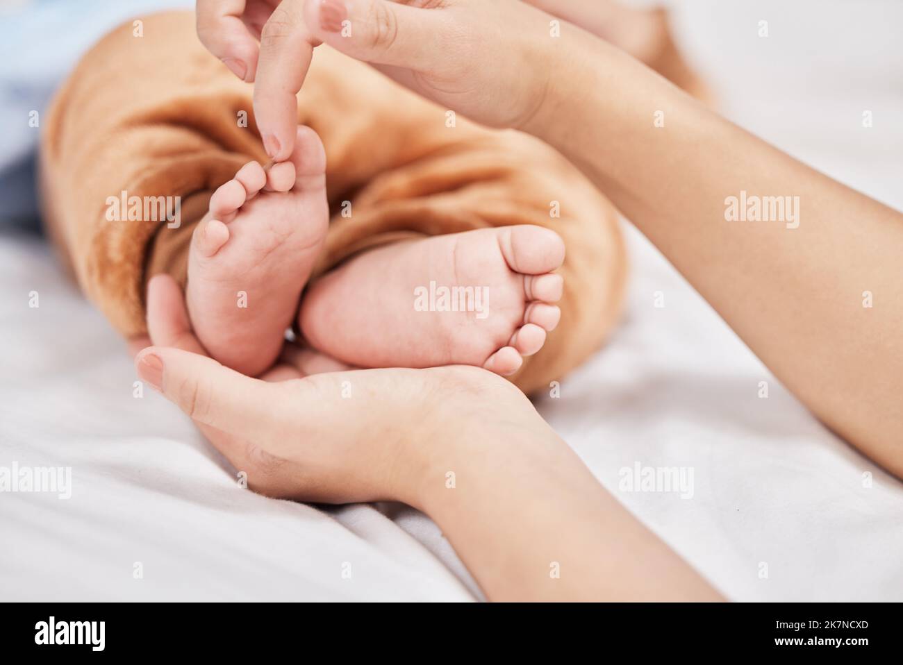 Hand holding feet hi-res stock photography and images - Alamy