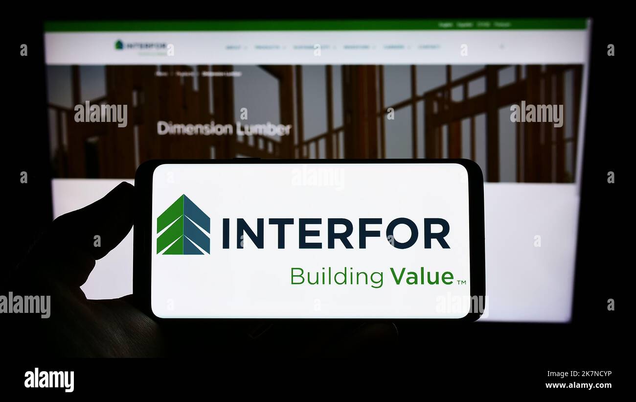 Person holding smartphone with logo of Canadian forestry company ...