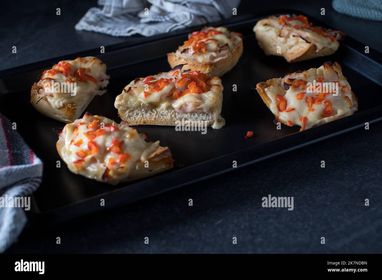 Baked sandwiches with chicken ham, cheese and bell peppers on german ...