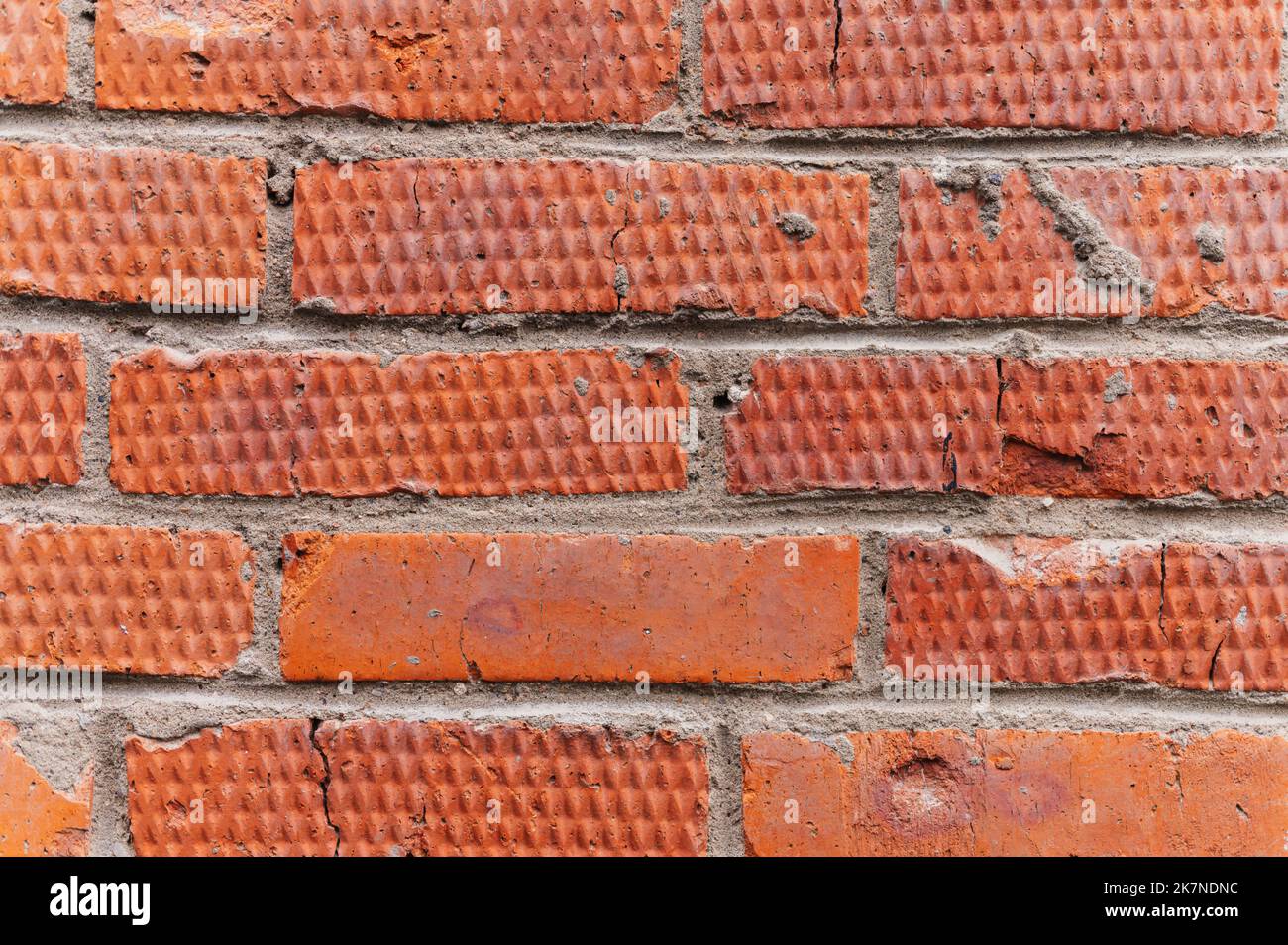 background of red textured relief brick. aged old stone wall or street ...