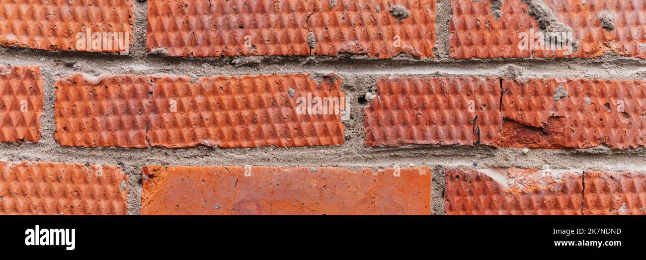 background of red textured relief brick. aged old stone wall or street ...