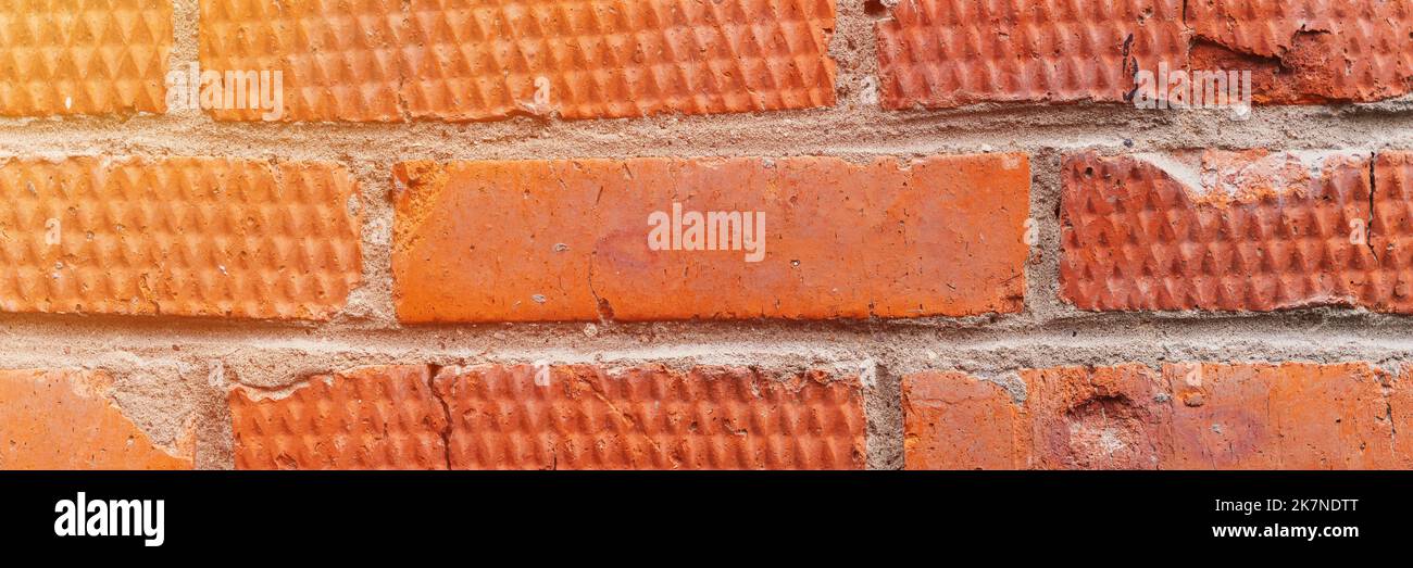 background of red textured relief brick. aged old stone wall or street ...