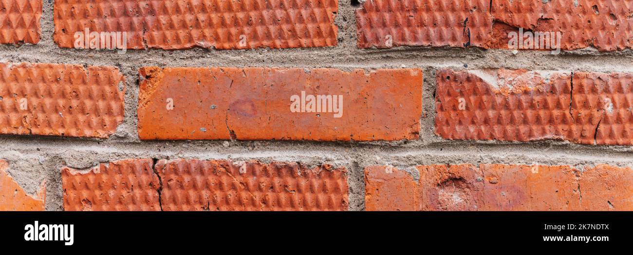 background of red textured relief brick. aged old stone wall or street ...