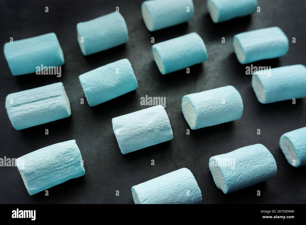 Blue marshmallows on dark background Stock Photo - Alamy