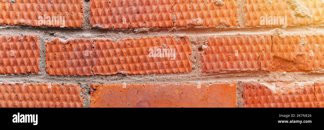 background of red textured relief brick. aged old stone wall or street ...