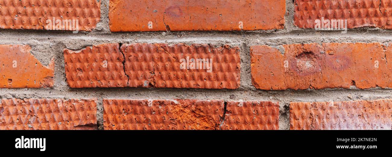 background of red textured relief brick. aged old stone wall or street ...