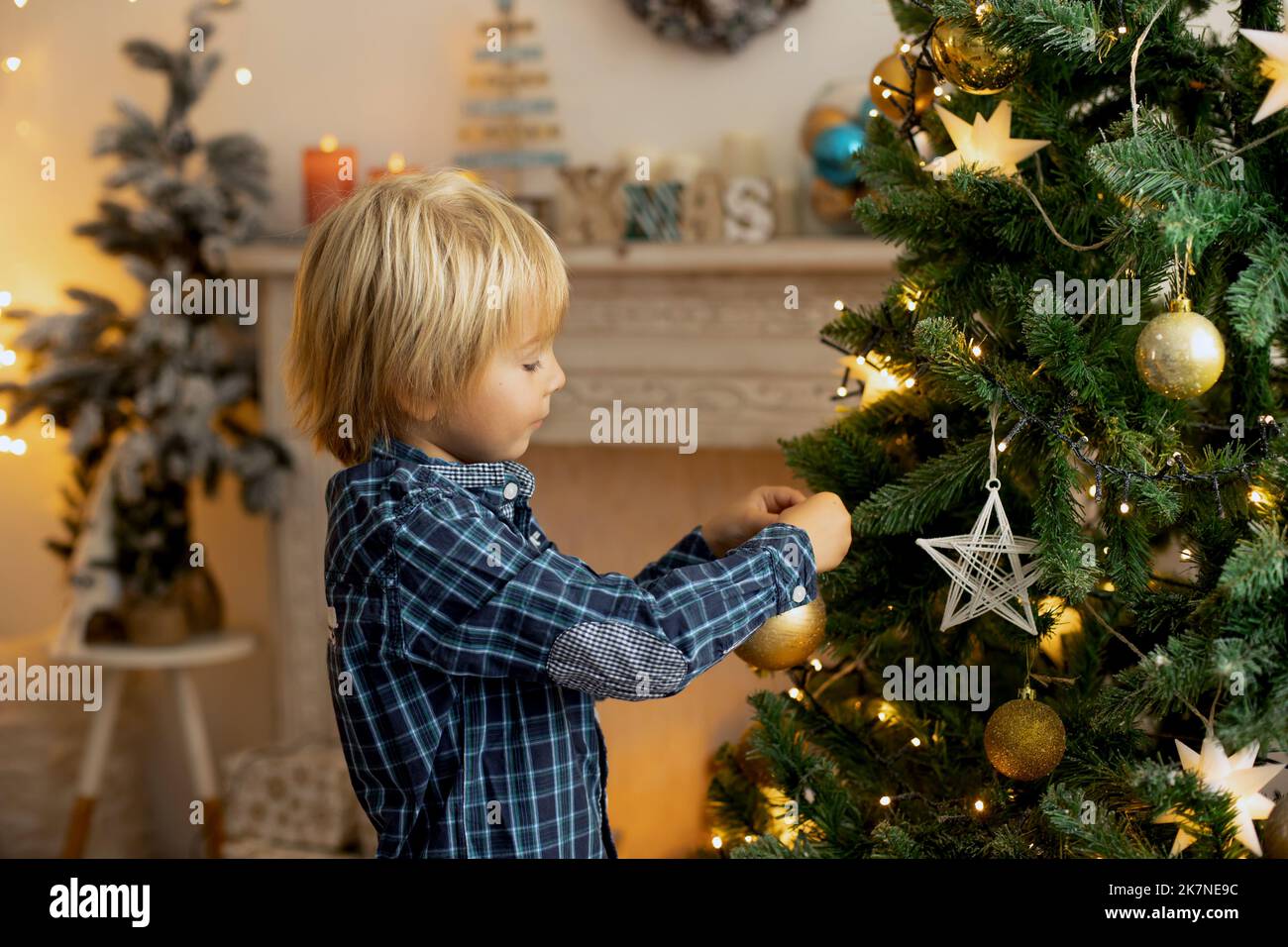 Cute child, boy, playing in a decorated room for Christmas, cozy place ...