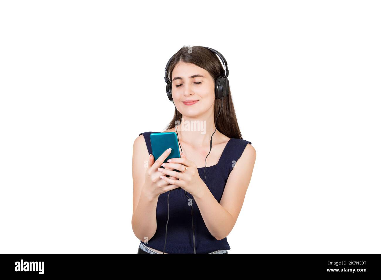 Relaxed casual woman listening calming music on headphones, holding her ...