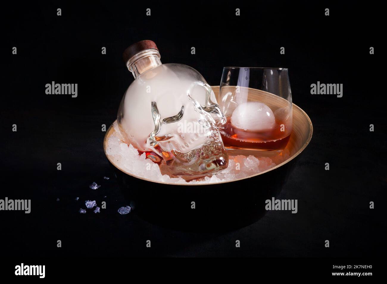 Serving an alcoholic cocktail based on rum in a skull-shaped bottle ...