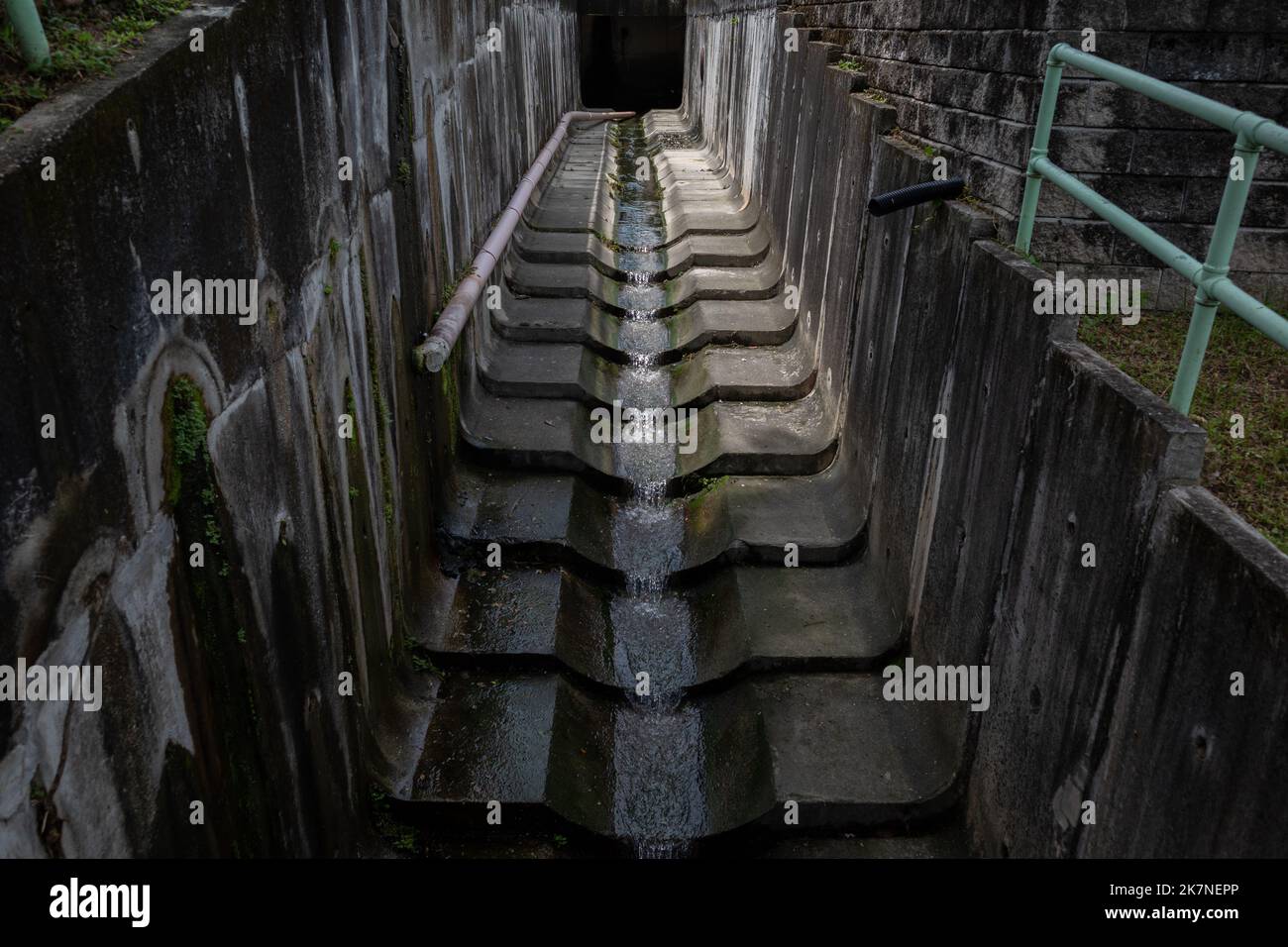 A large concrete monsoon drain with some water during the dry season ...