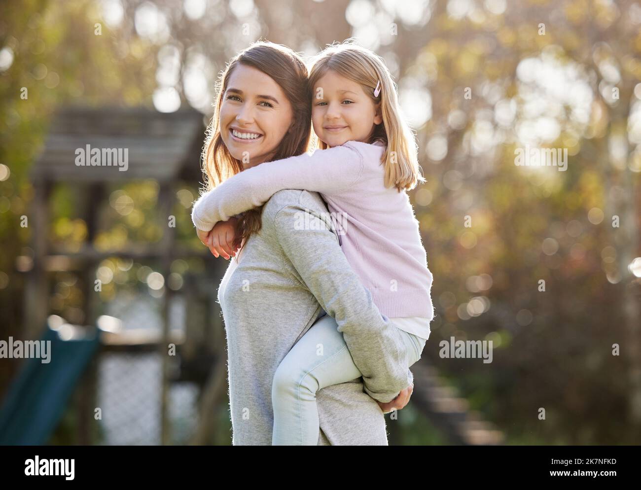 She loves piggyback rides. Cropped portrait of an attractive young ...