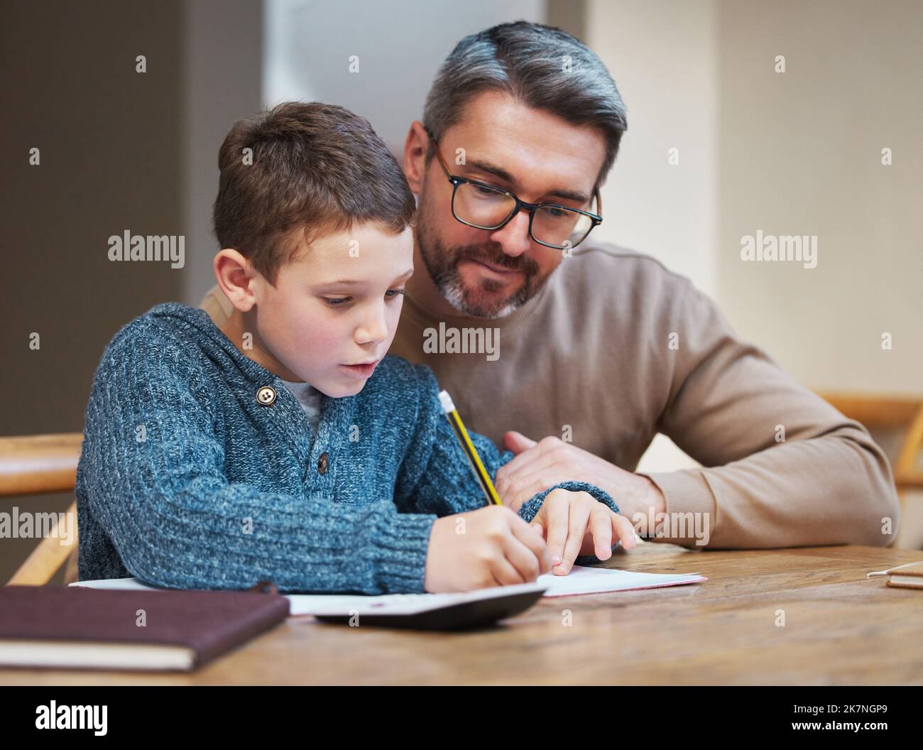 Take your time and youll get it. a father helping his son complete his ...