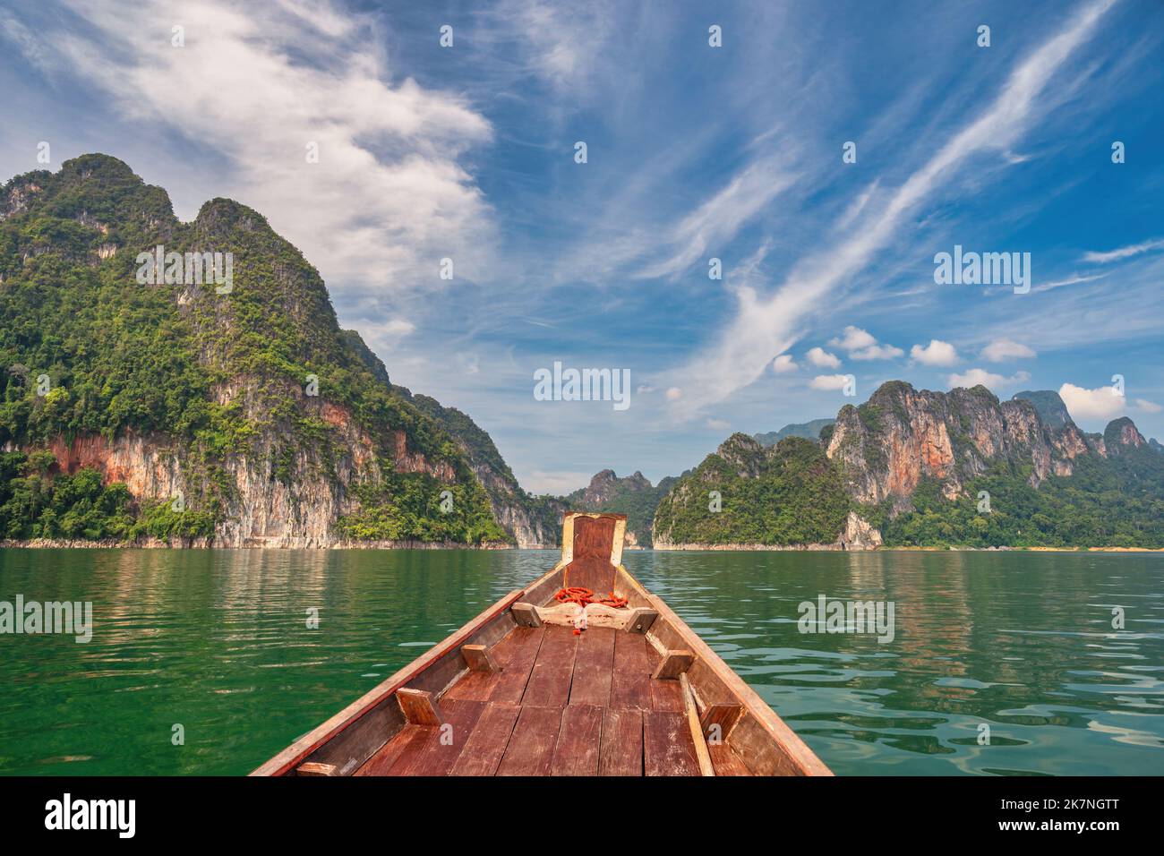 Boat riding through mountain lake view with tropical forest at Sam Klur ...