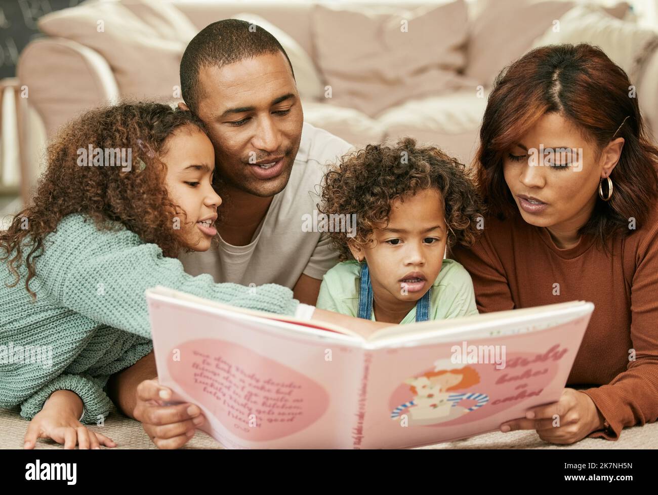 This is a family favourite book. a young family reading a book at home ...
