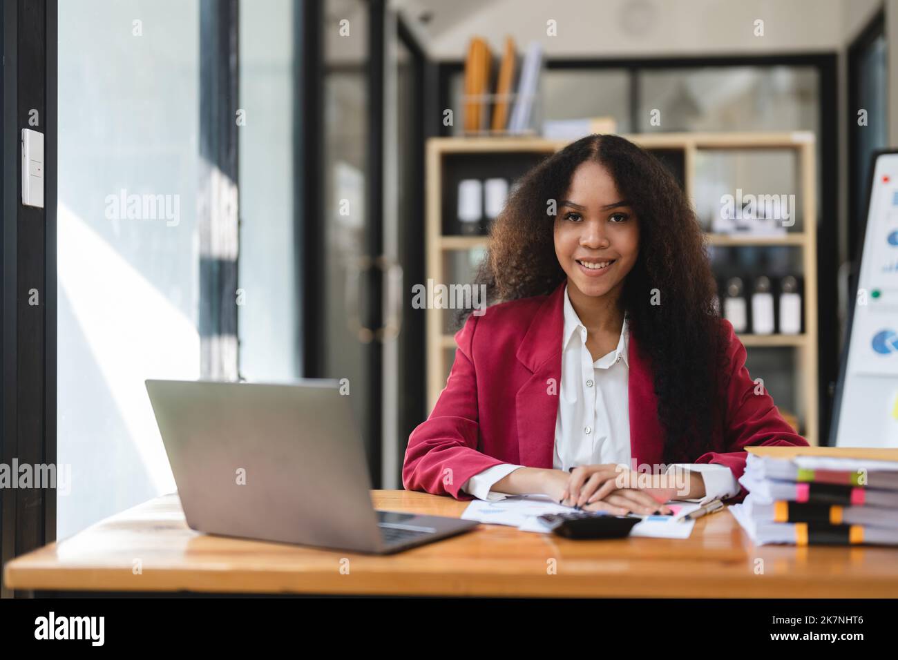 Black Businesswoman Sitting at Her Desk Working on a Laptop Computer ...