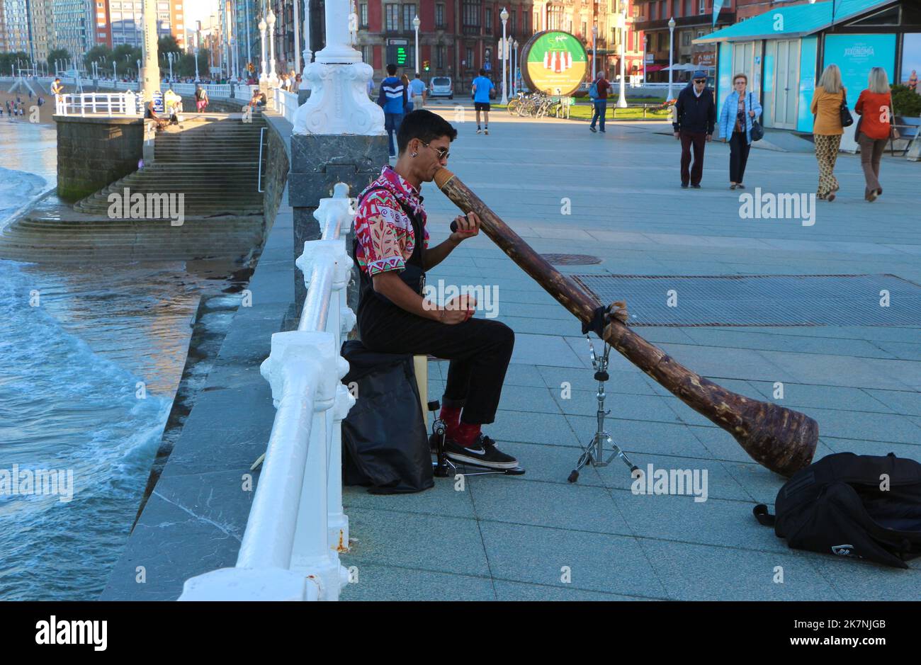 A young man playing a traditional Mayan trumpet on the promenade Paseo ...