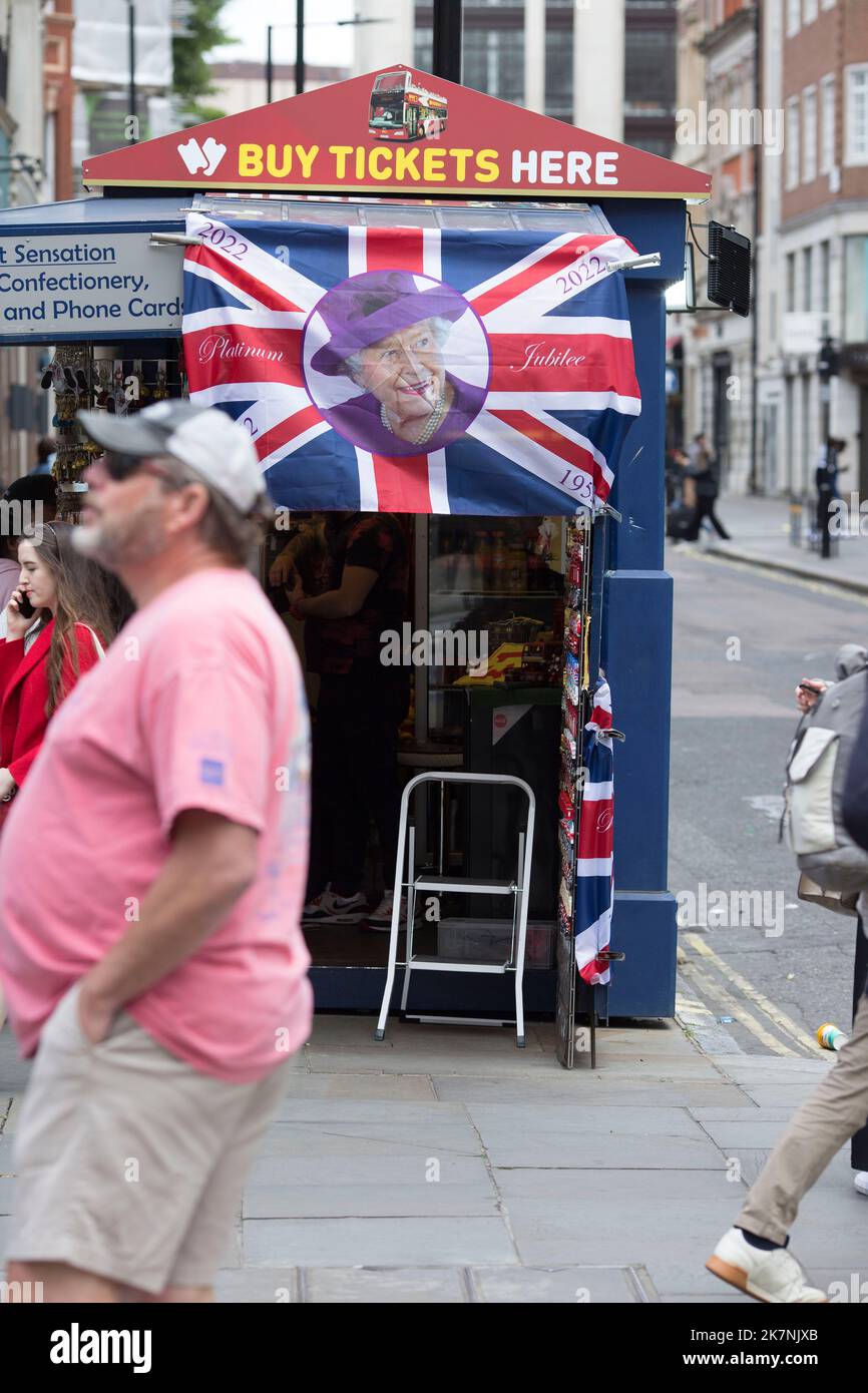 A Union flag featuring a portrait of Queen Elizabeth II is displayed at ...