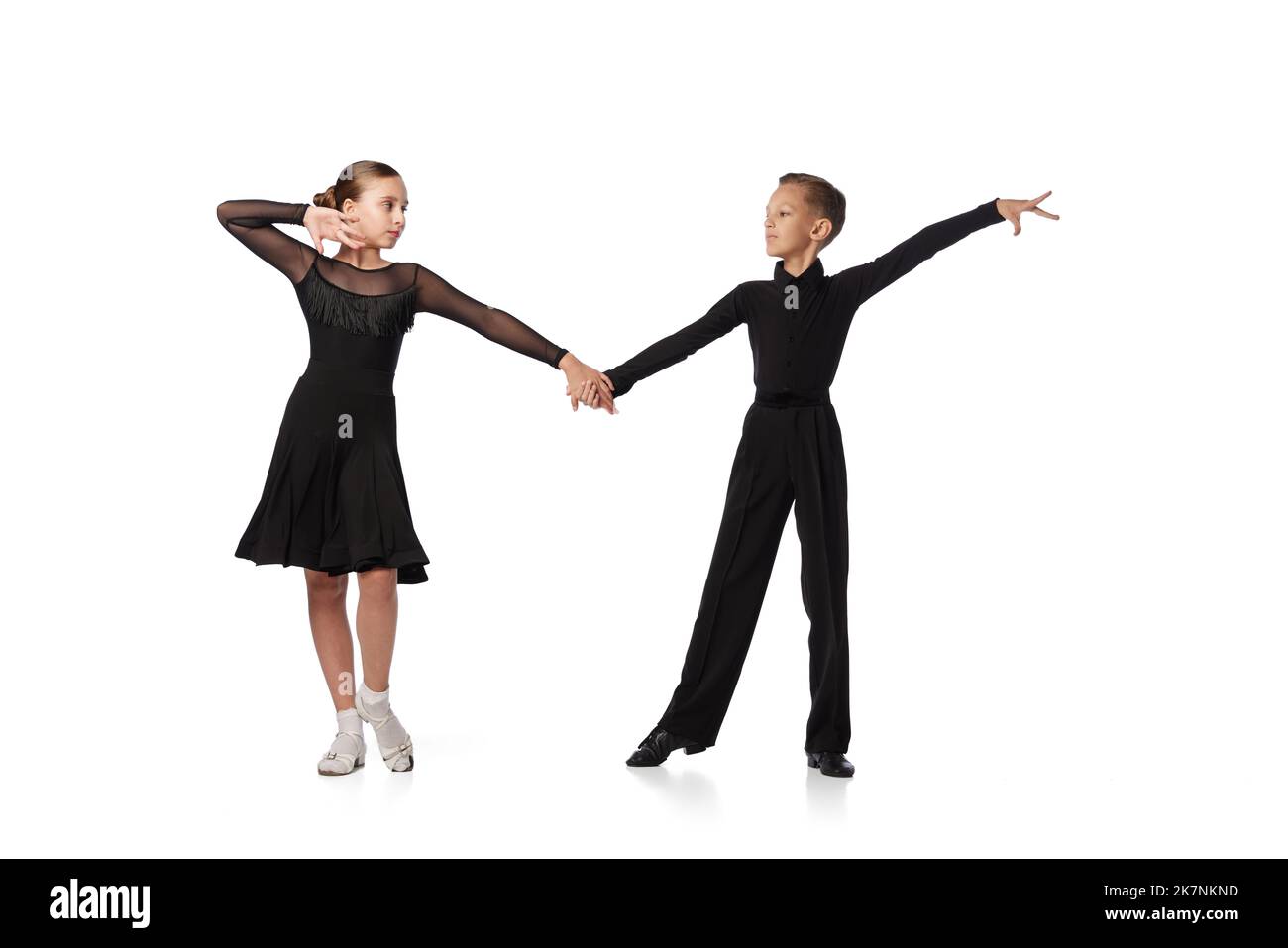 Dance couple. Two kids, school age girl and boy in black stage costumes ...