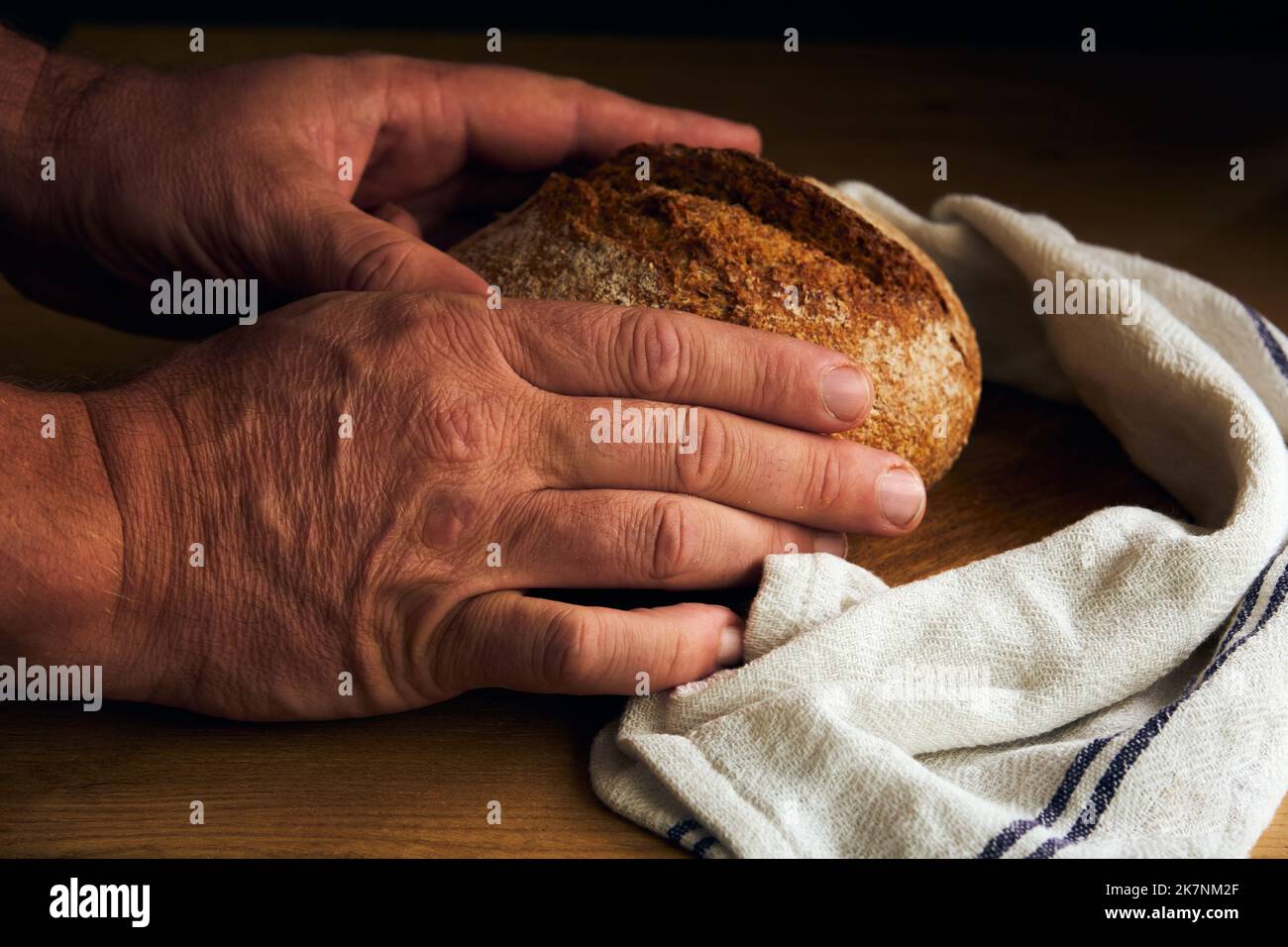black bread in men's hands Stock Photo - Alamy