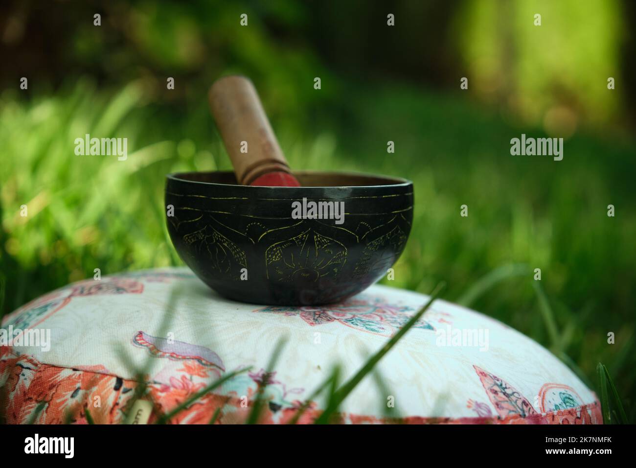 Tibetan bowl with a stick on the grass Stock Photo - Alamy