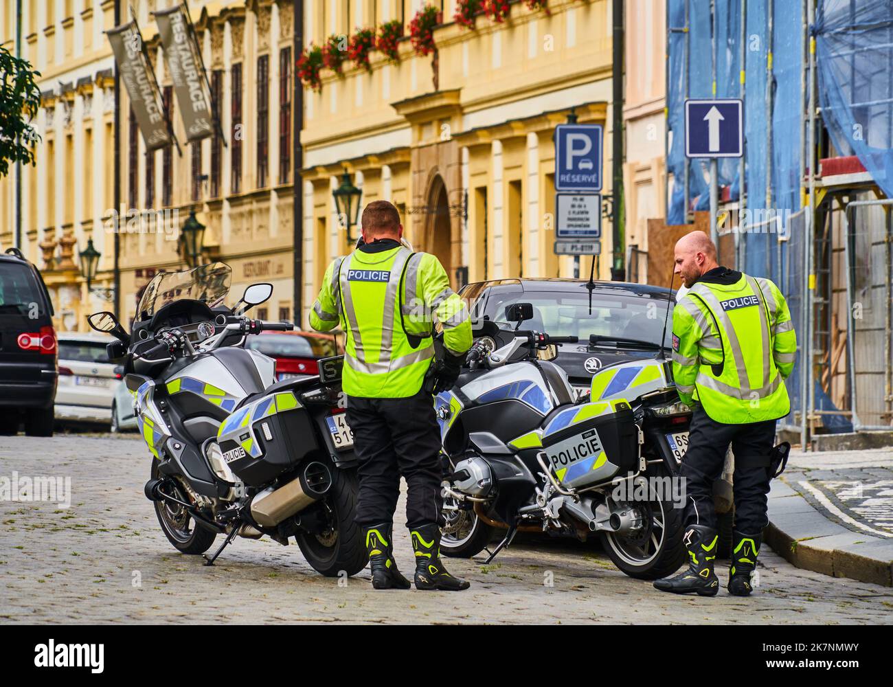 Prague, Czechia, August 30, 2022: Police officers in flares stand next ...