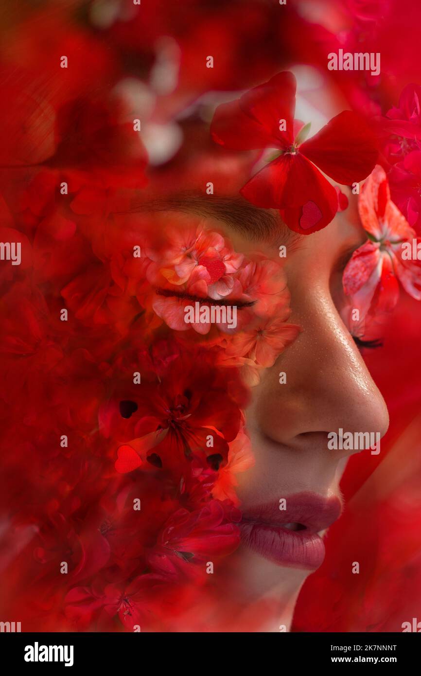 Red Flower Blossoms are blooming on a female, calm face with closed ...