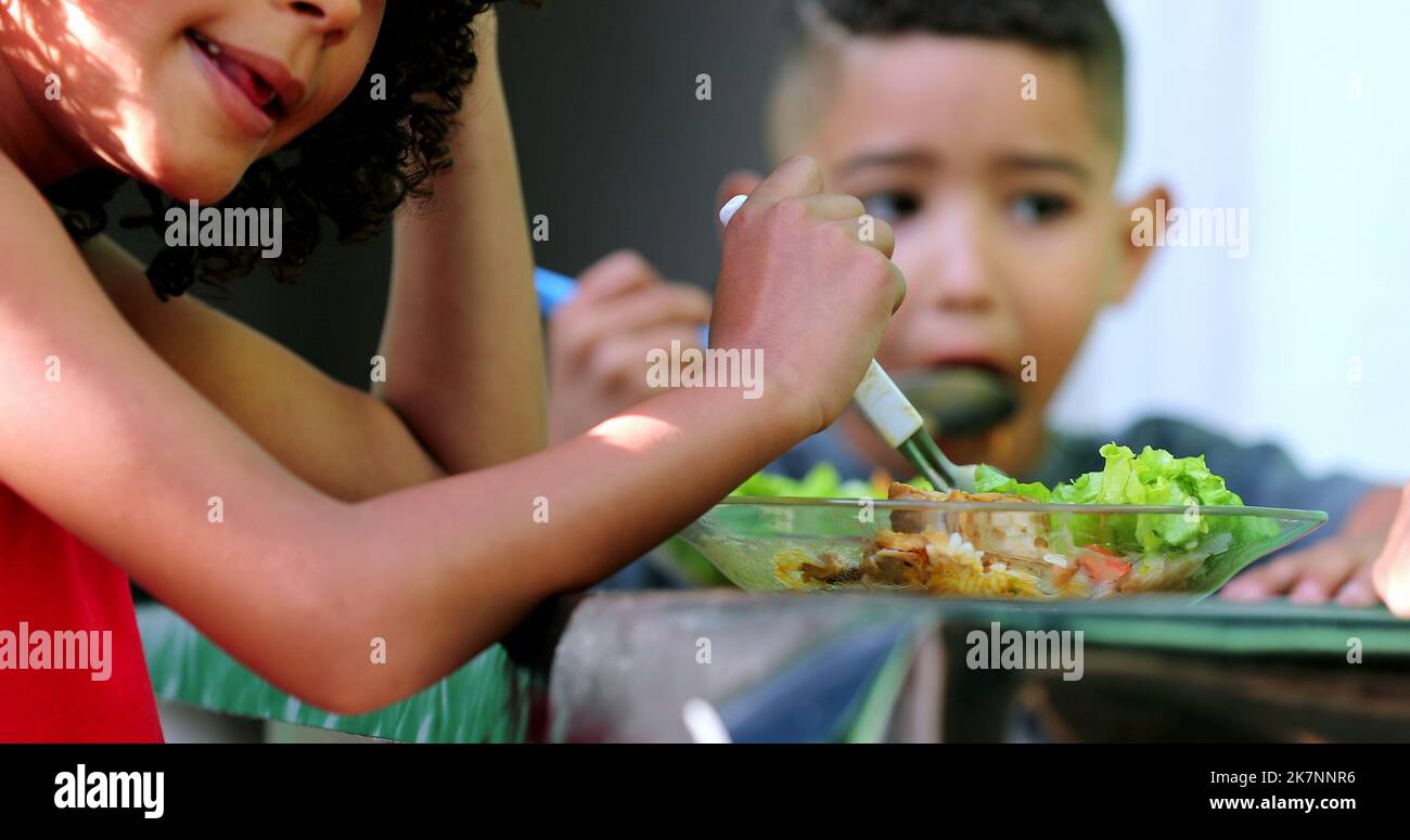 Children eating plate of salad, kids eat lunch Stock Photo - Alamy
