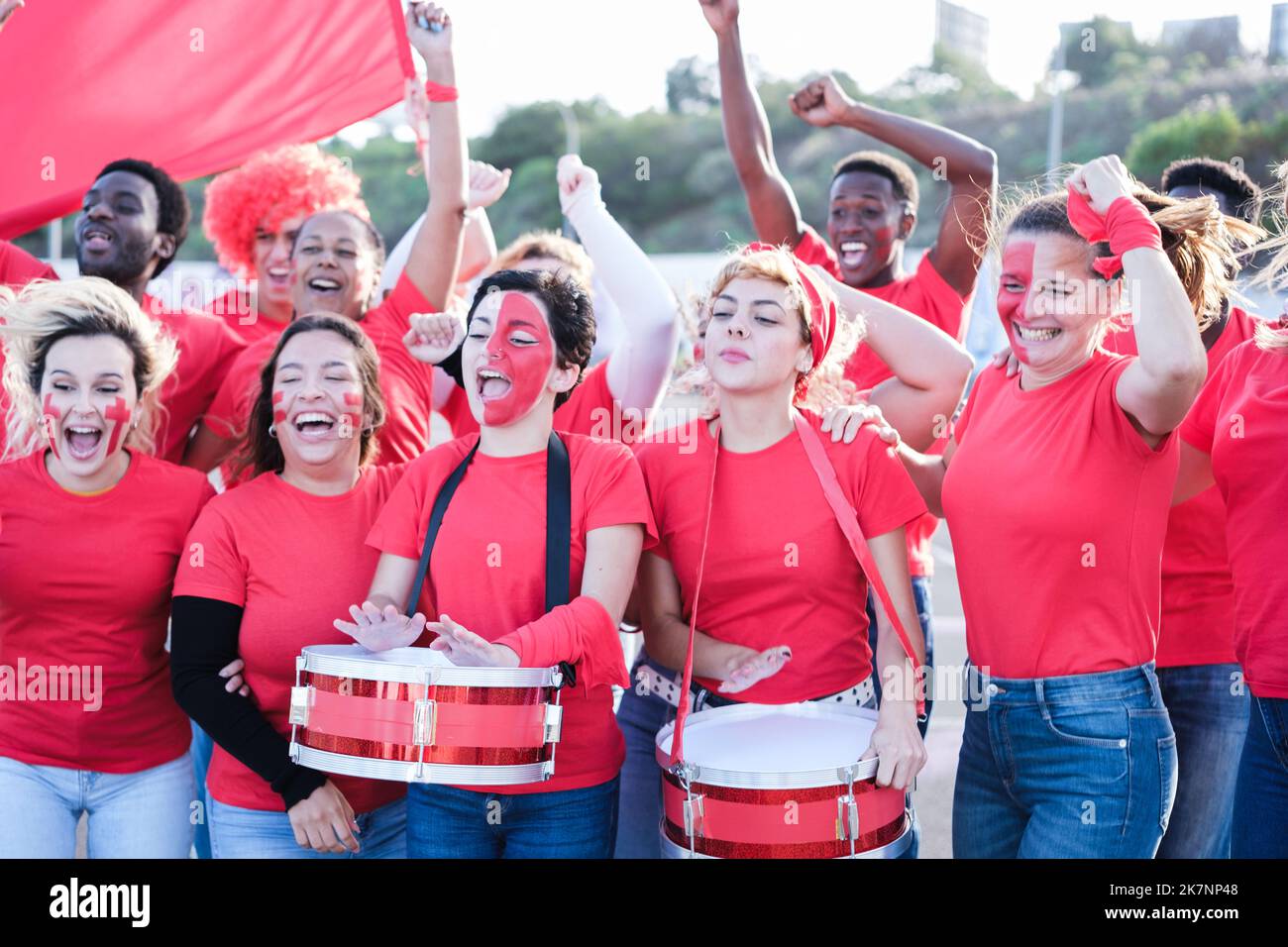 Group of fans cheering their team with flags and drums before the new ...