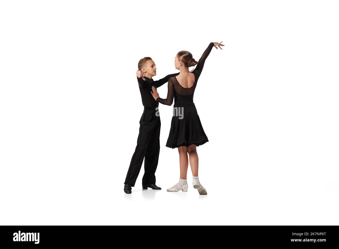 Dance couple. Two kids, school age girl and boy in black stage costumes ...