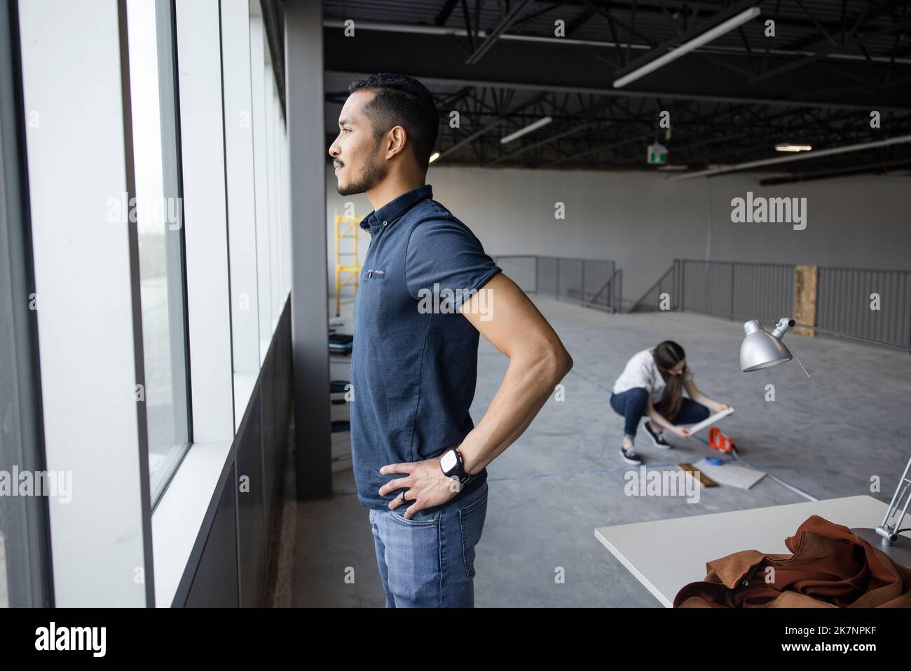 Office building with man looking out window hi-res stock photography ...
