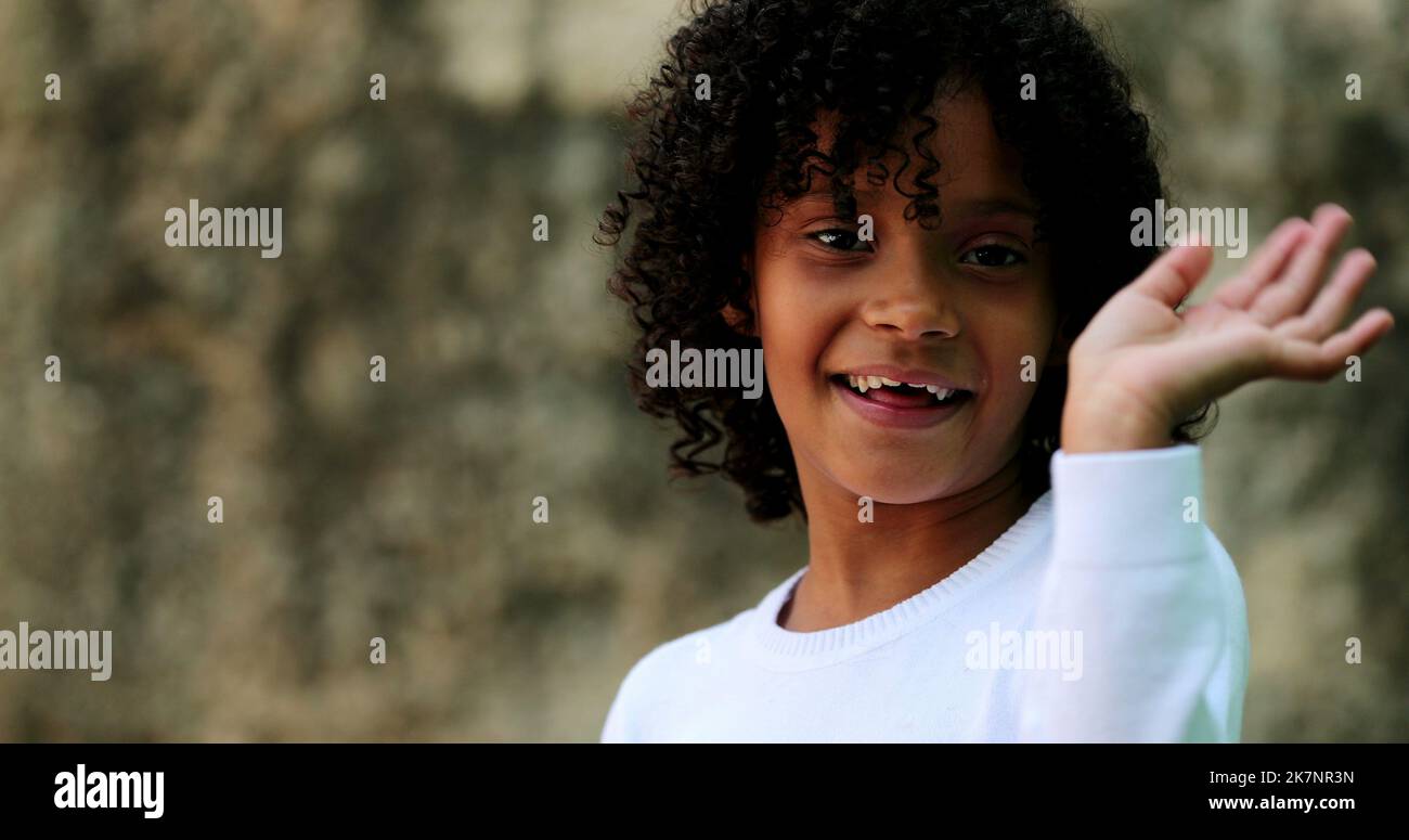 Brazilian little girl waving hello to camera. child waves hi Stock ...