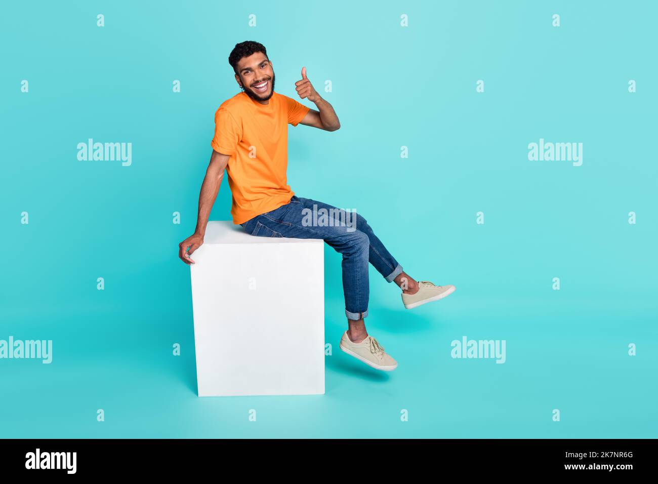 Full length photo of positive person sit podium demonstrate thumb up ...
