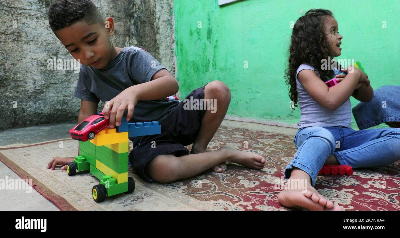 Brazilian children playing outside in backyard toys, hispanic south ...