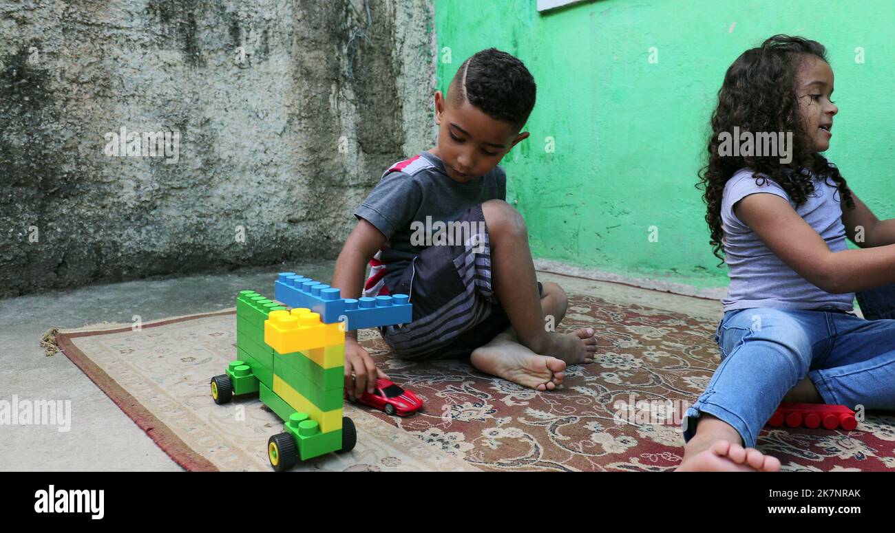 Brazilian children playing outside in backyard toys, hispanic south ...