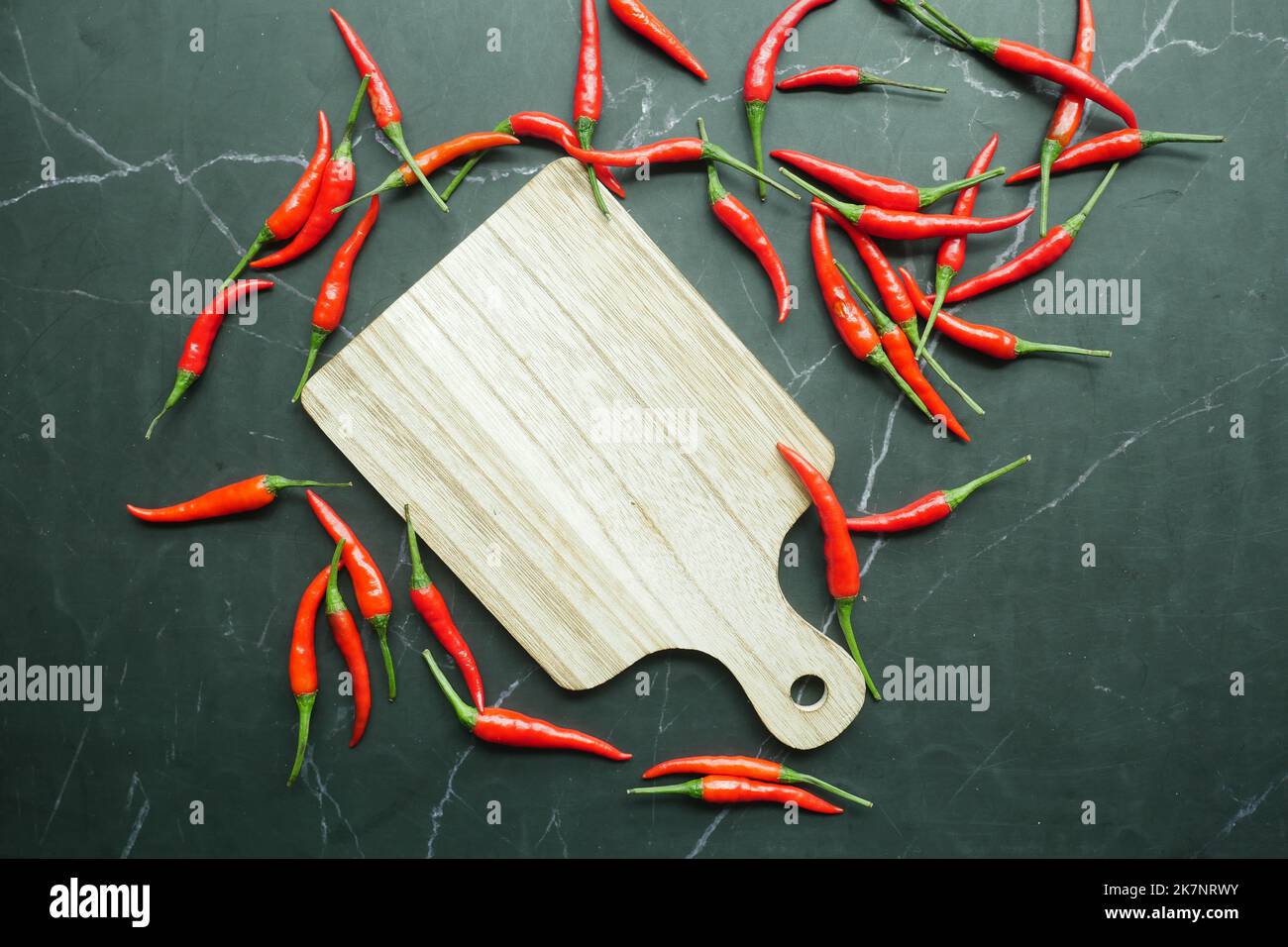 wooden chopping board and red chili on black background top down Stock ...