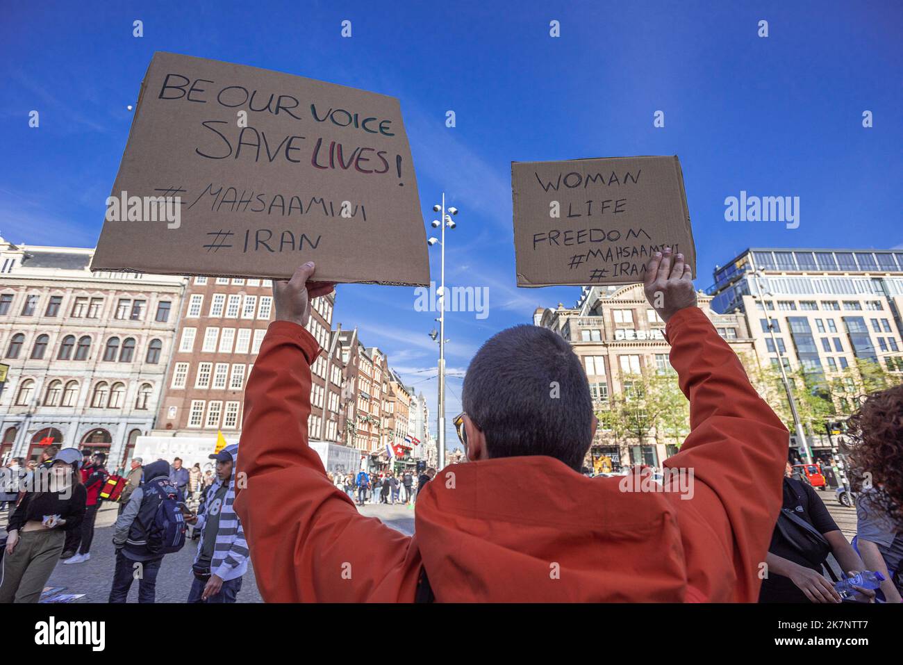 A man holds placards expressing his opinion during the ‘Woman Life ...