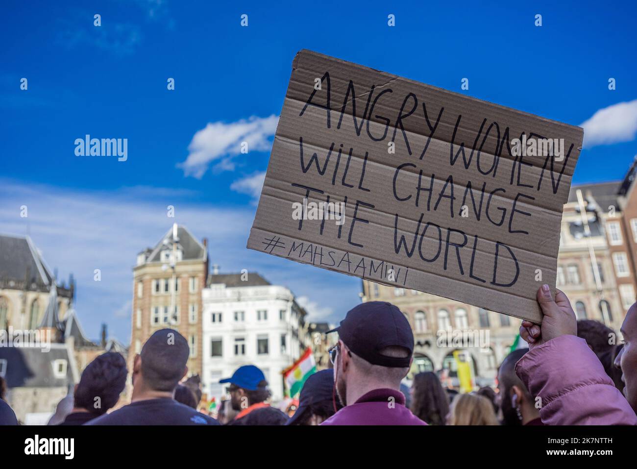 A man holds a placard expressing his opinion during the ‘Woman Life ...