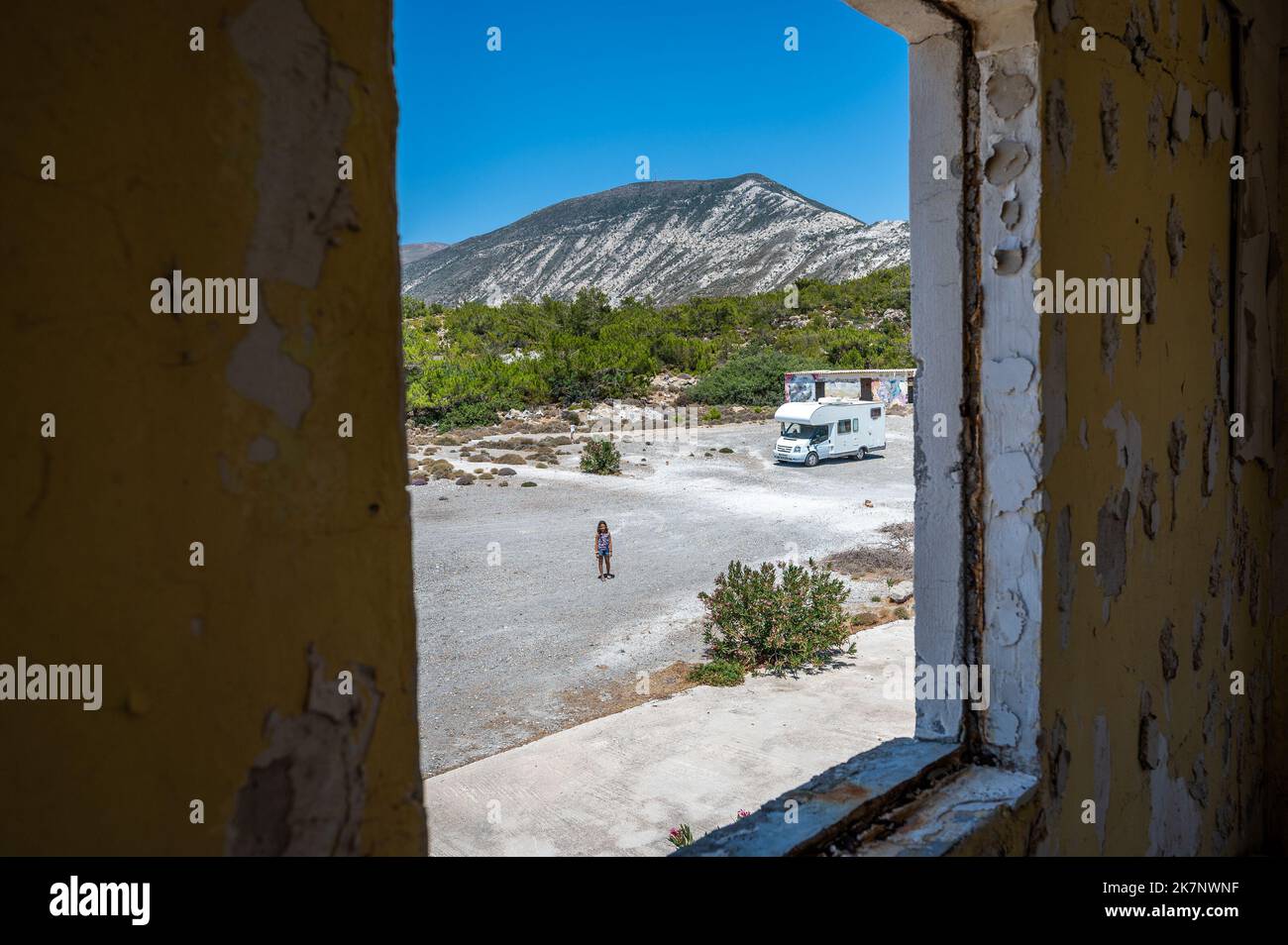 Family with motorhome exploring abandoned factory buildings in Crete ...