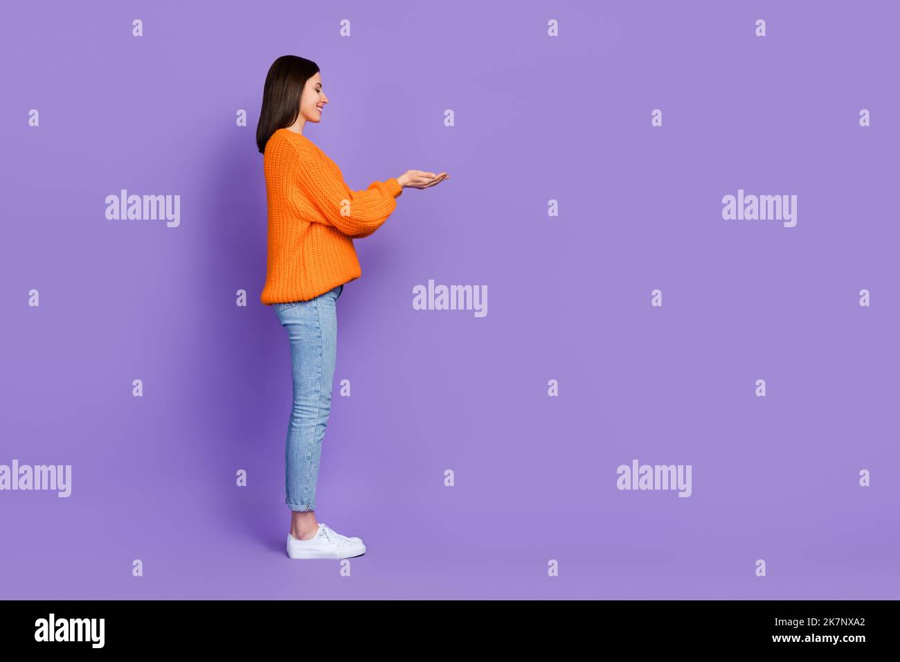 Full body profile portrait of positive person hands hold empty space ...