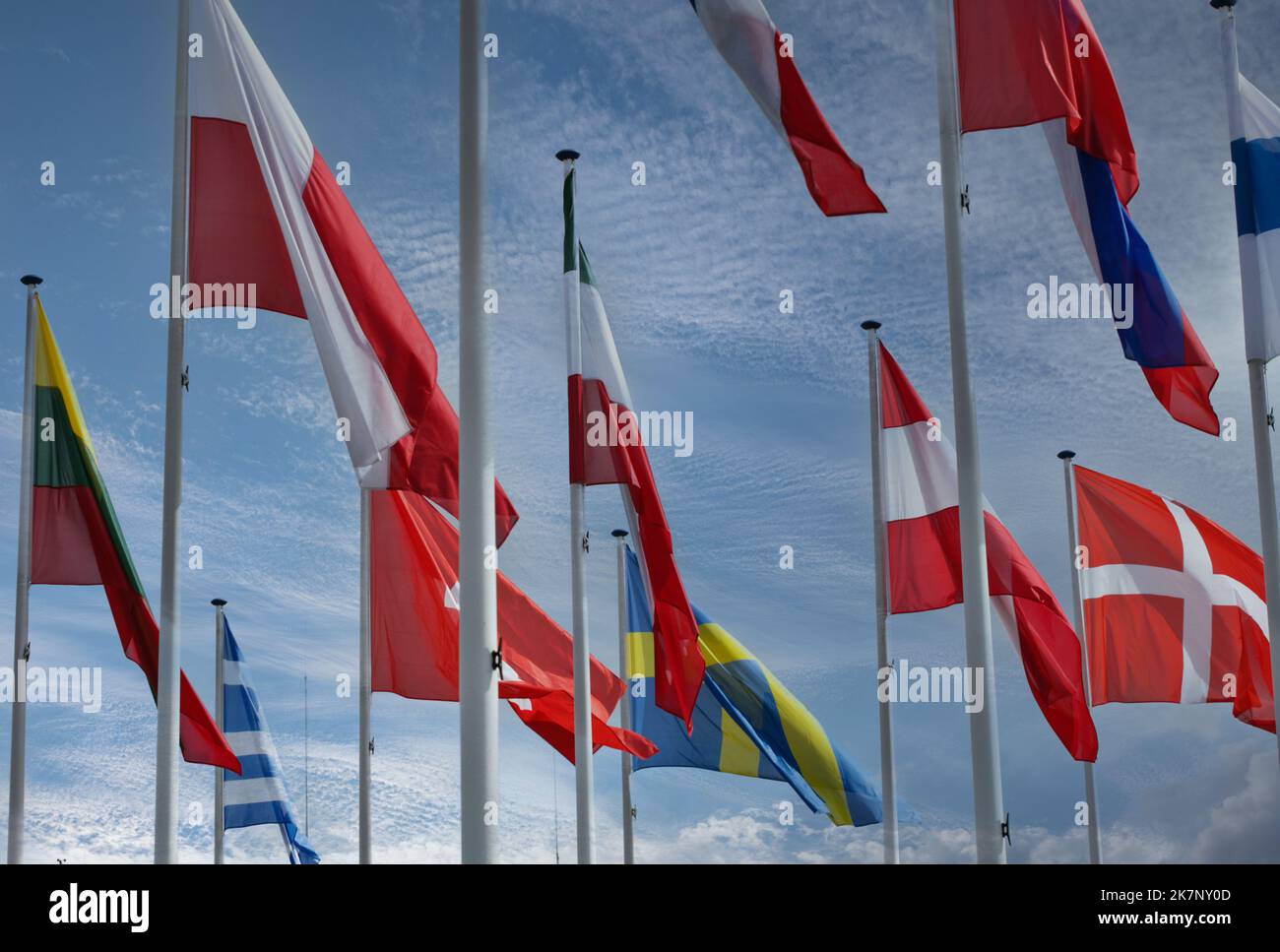 flags in the wind and sun with cloudy sky Stock Photo - Alamy