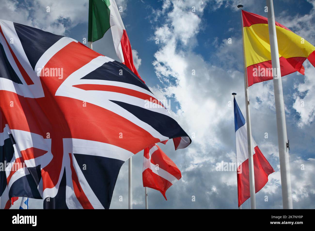 flags in the wind and sun with cloudy sky Stock Photo - Alamy