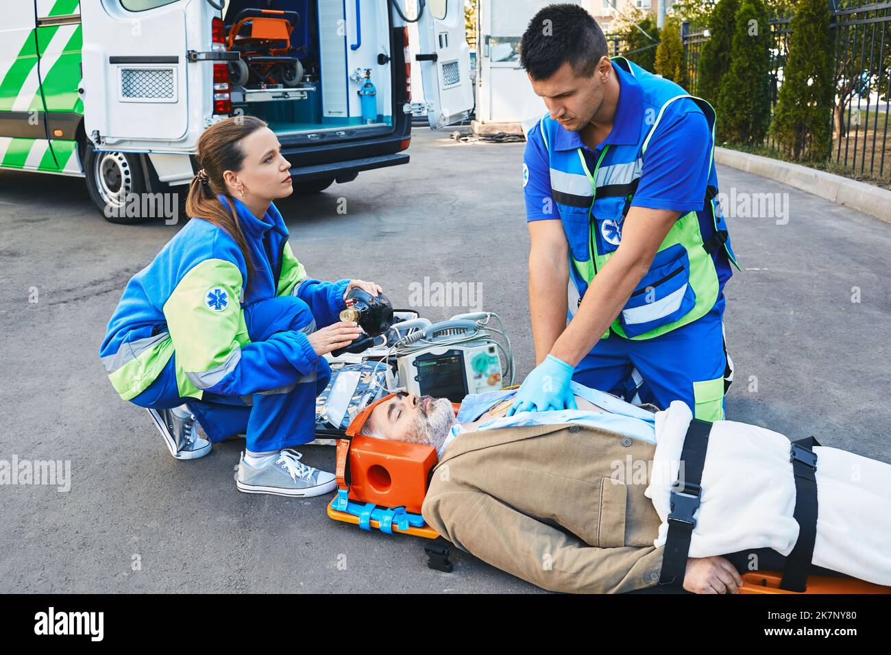 EMS, first aid. Two paramedics performing closed-chest cardiac massage ...