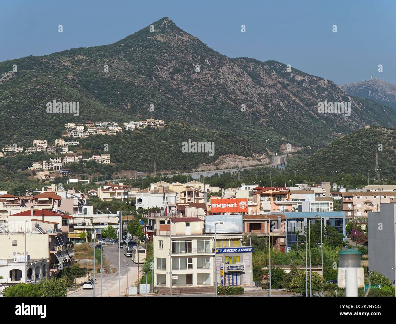 Varathi mountain rises behind the coastal town of Igoumenitsa, Greece ...